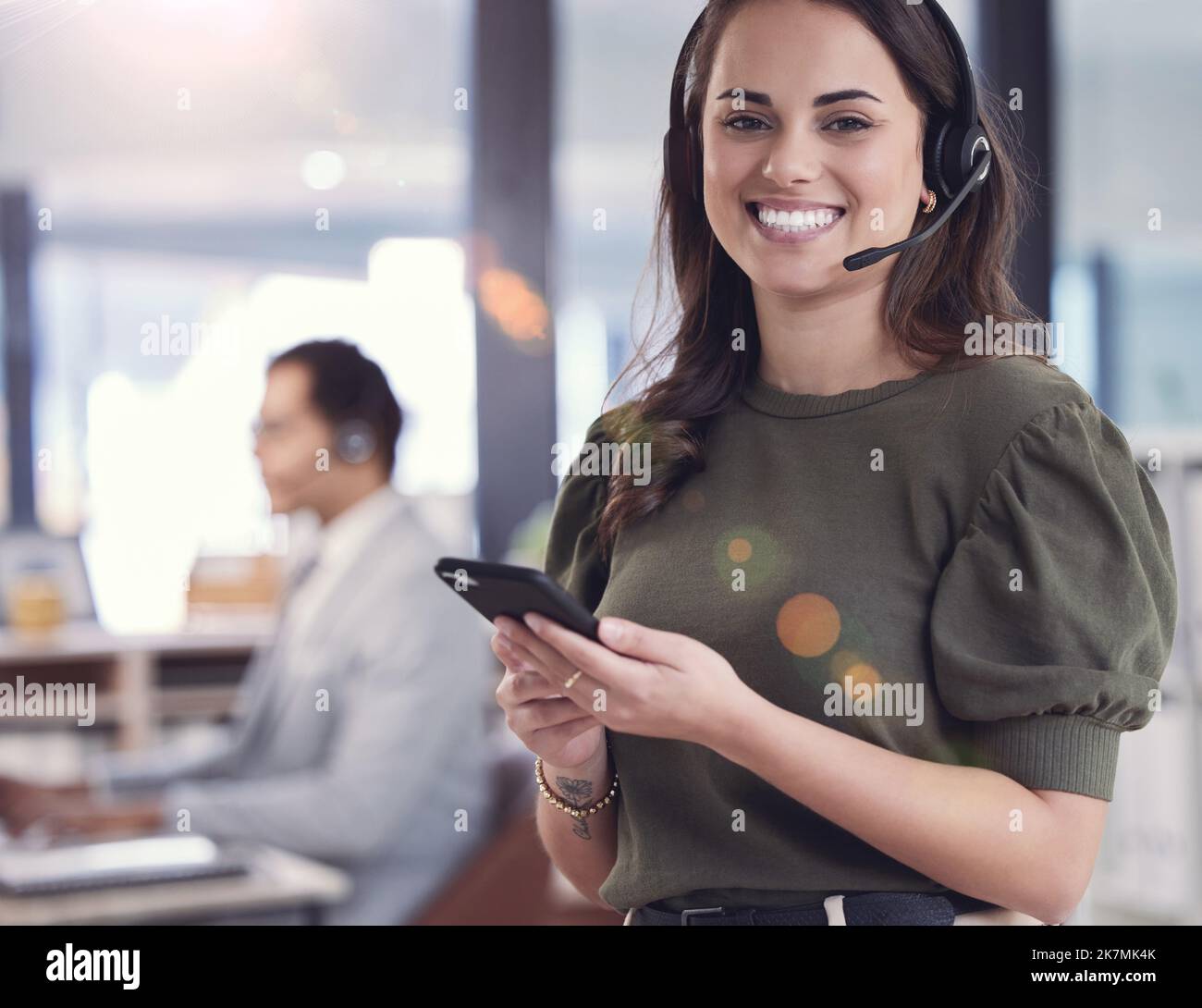 Customer care is my passion. a young female call center agent using a ...