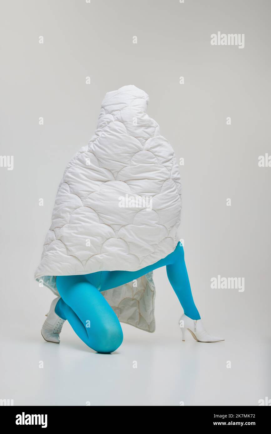 Portrait of young girl in blue tights, covered with blanket isolated ...