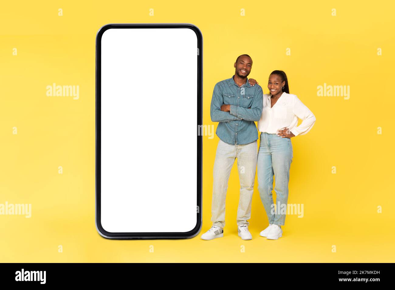 Happy Black Couple Standing Near Large Mobile Phone, Yellow Background ...