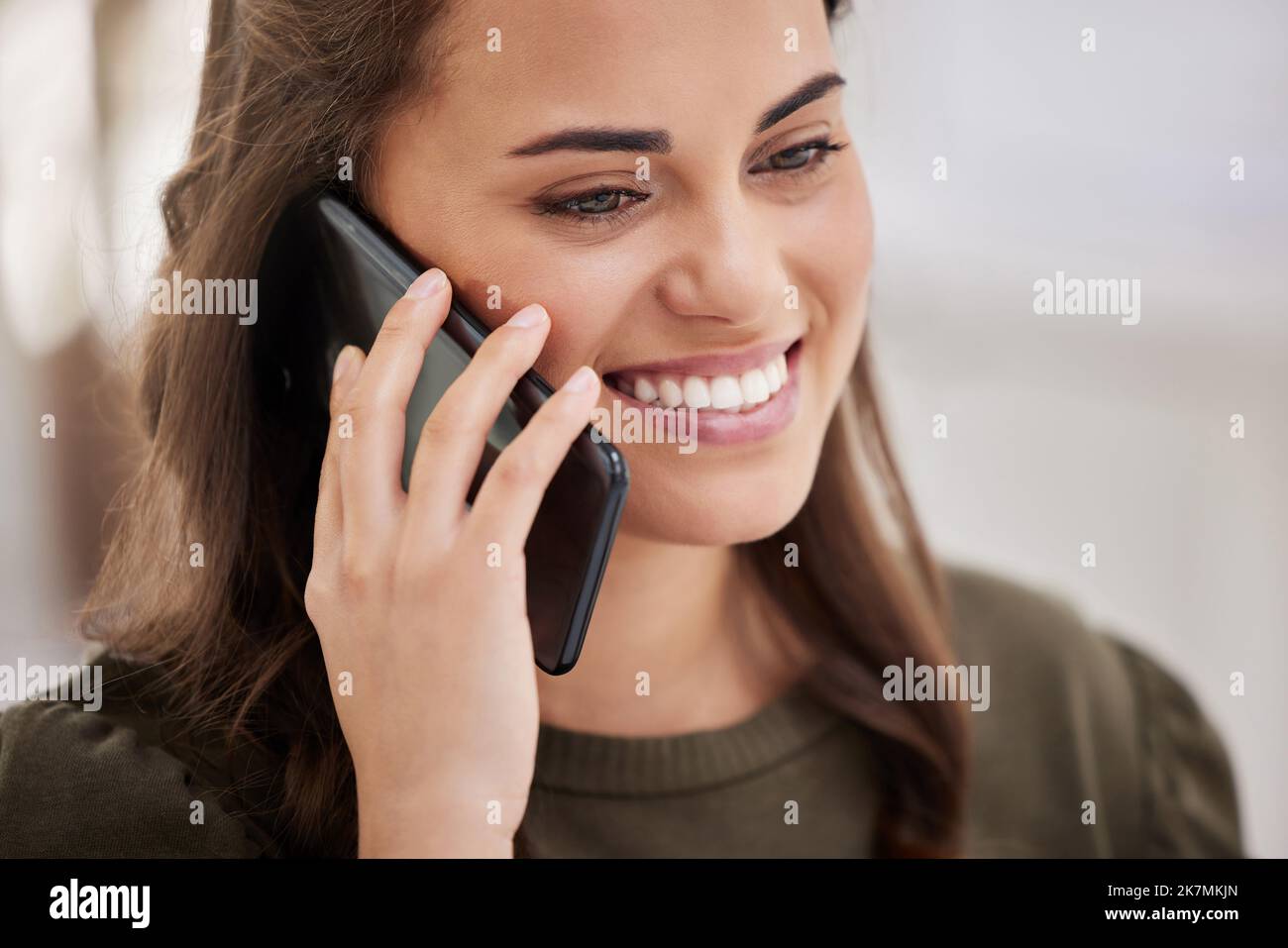 Shes always ready to talk bsusiness. a young businesswoman talking on a ...