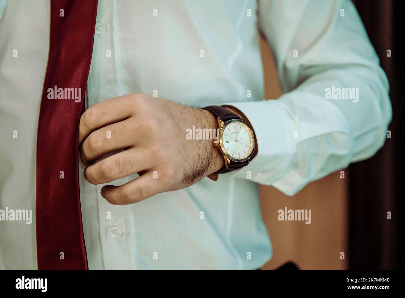 businessman checking time on his wrist watch, man putting clock on hand ...