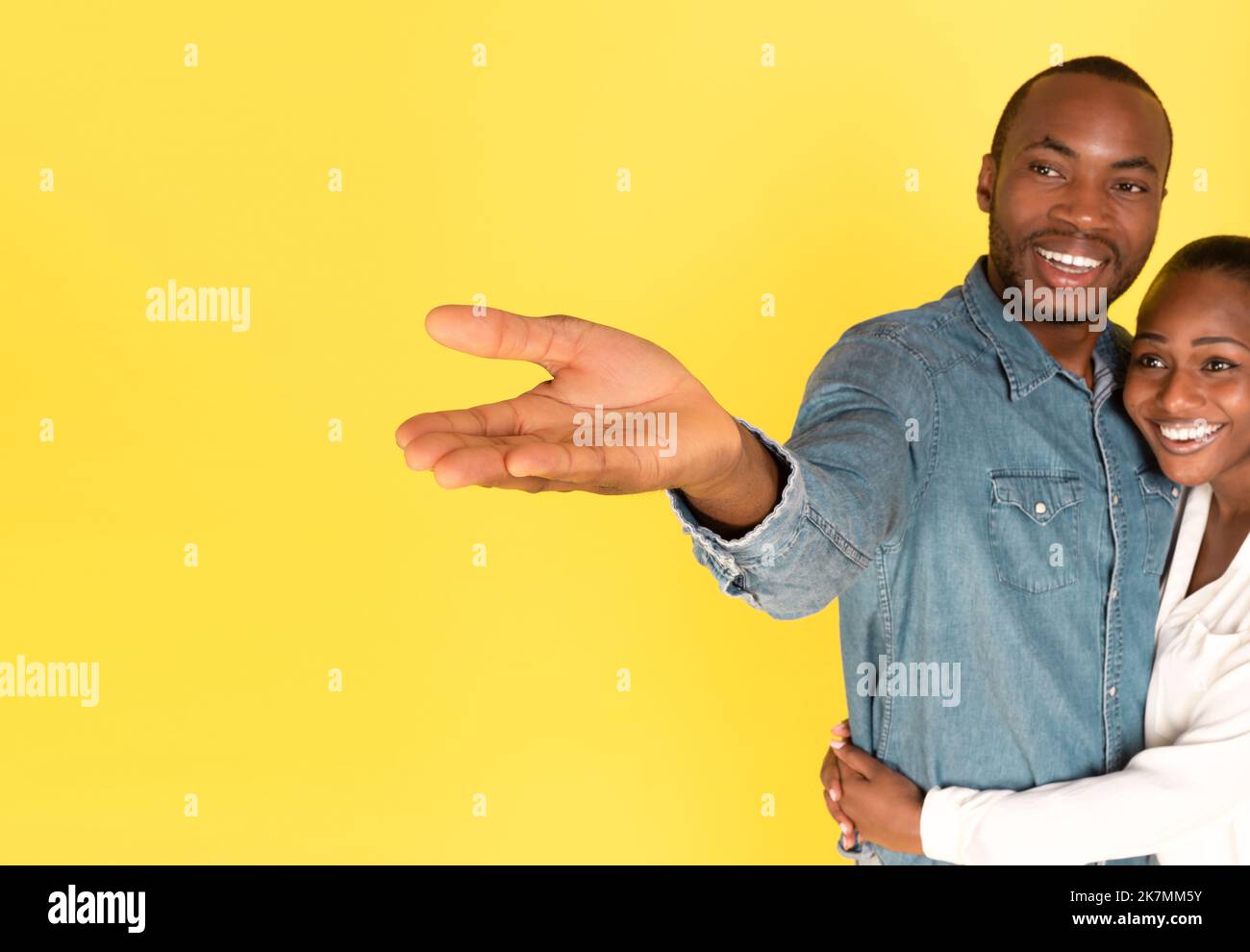 Smiling African American Couple Stretching Hand To Camera, Yellow ...