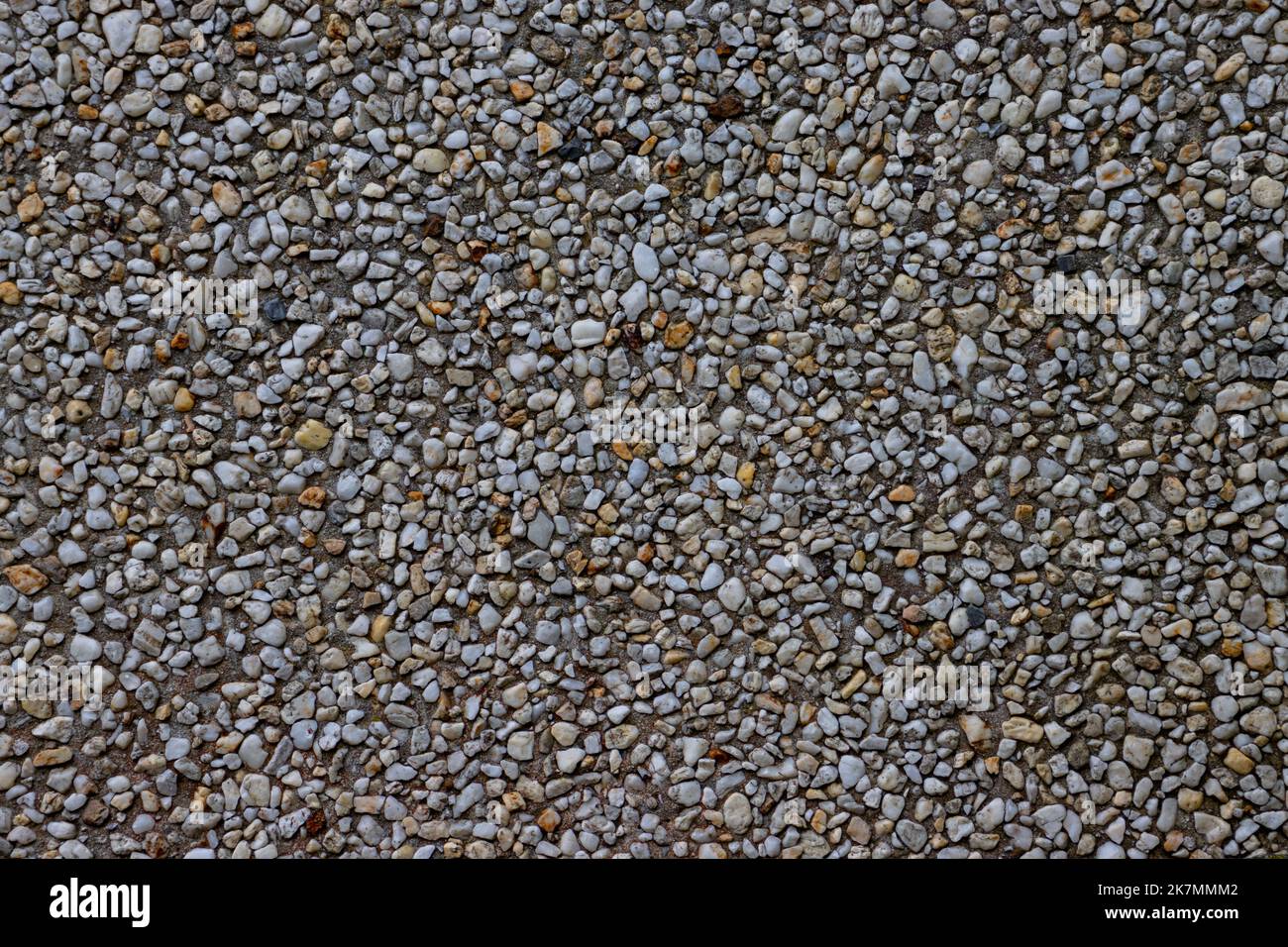 Small pebbles in concrete wall for background Stock Photo - Alamy