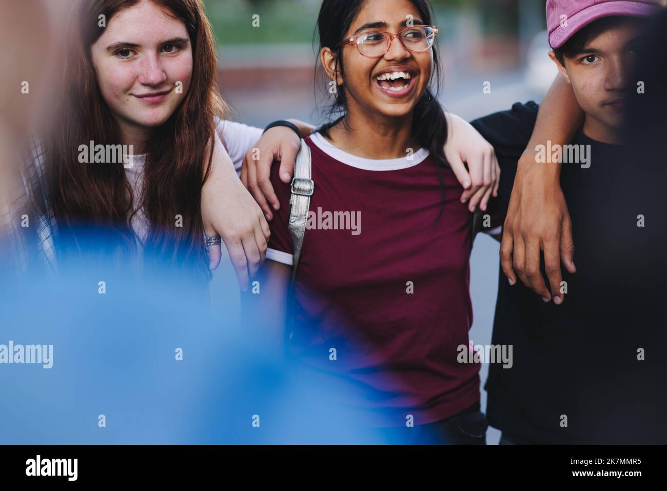 Group of happy teenage activists embracing each other and standing in a ...
