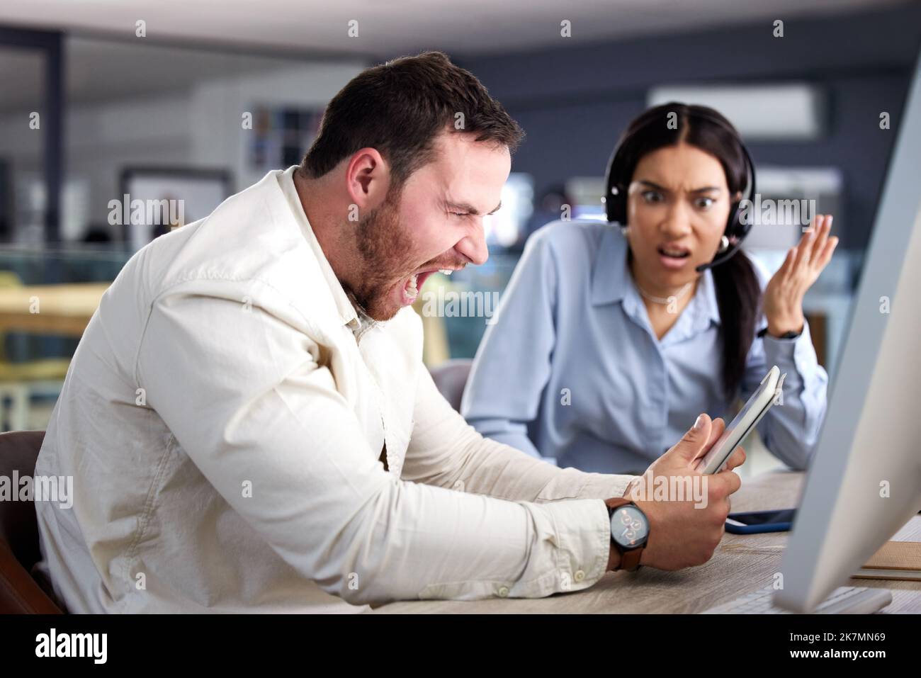 Why wont this thing work. a young businessman screaming and holding a ...