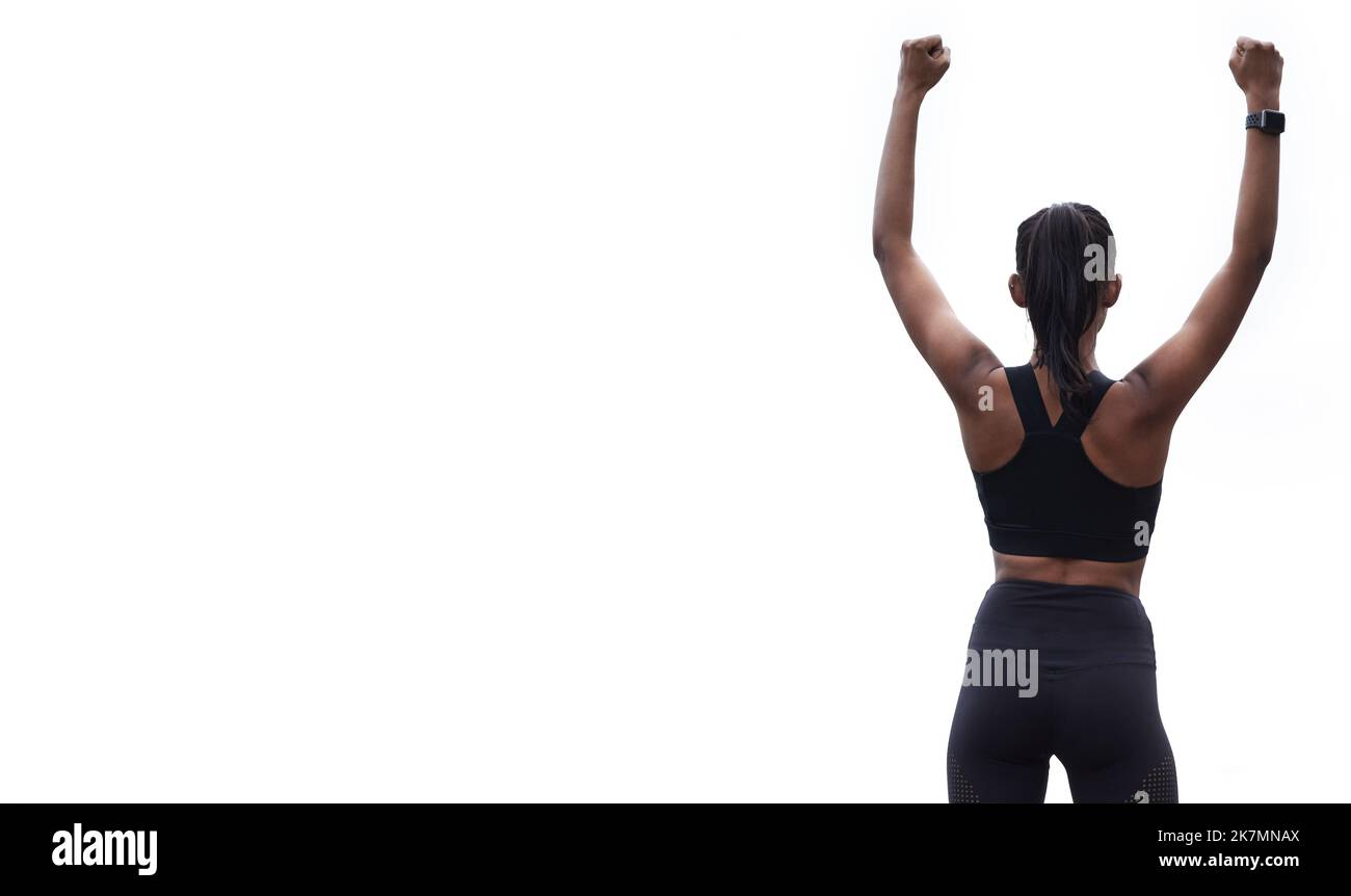 Go for your goals. Rearview shot of a sporty young woman cheering while ...