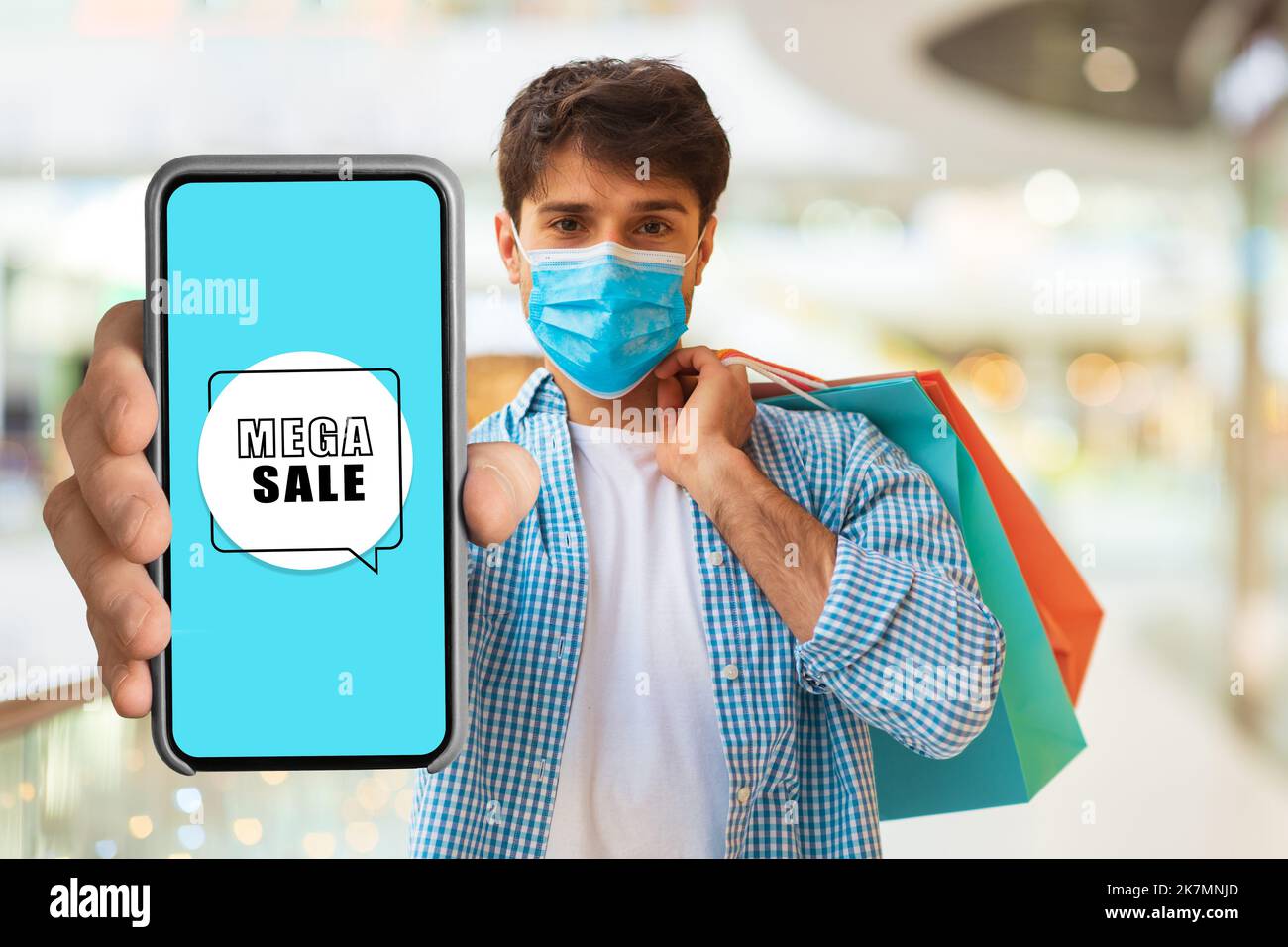 Man Showing Smartphone Advertising Sale Offer Shopping In Hypermarket ...