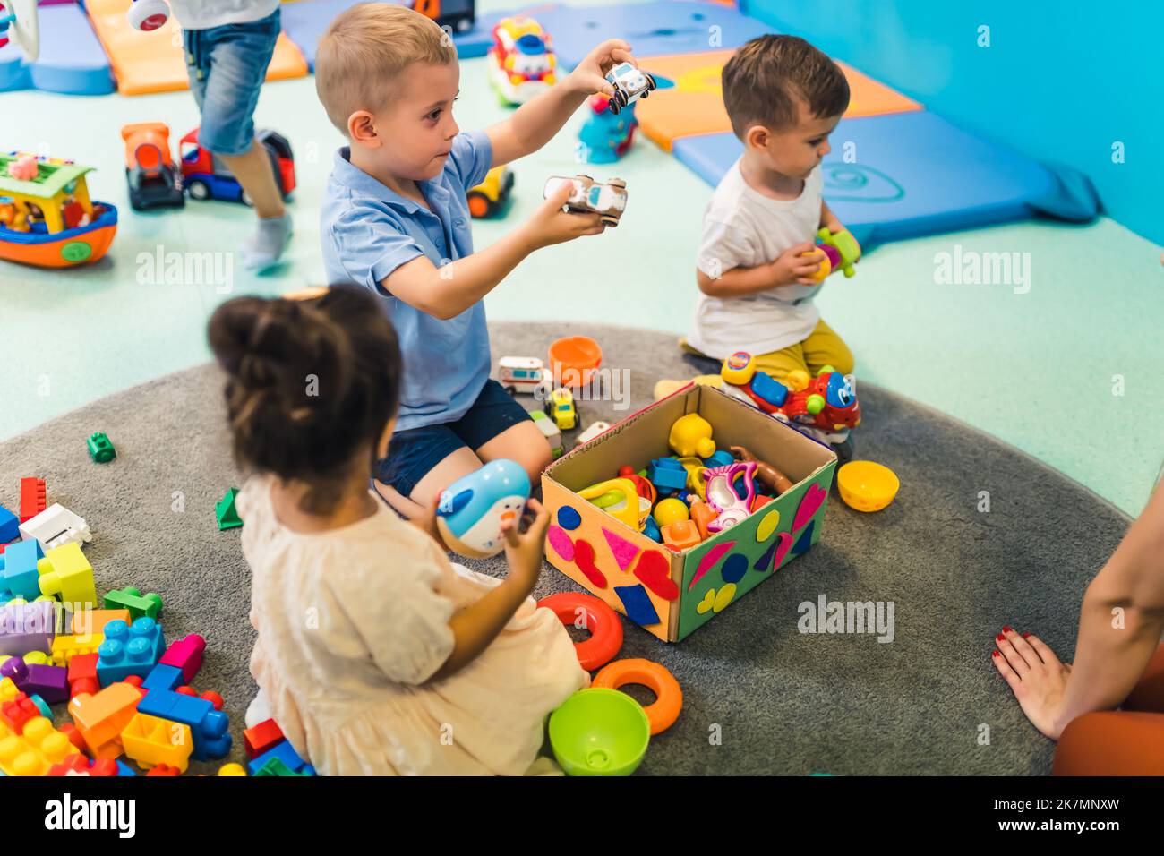 Children holding hands in classroom hi-res stock photography and images ...