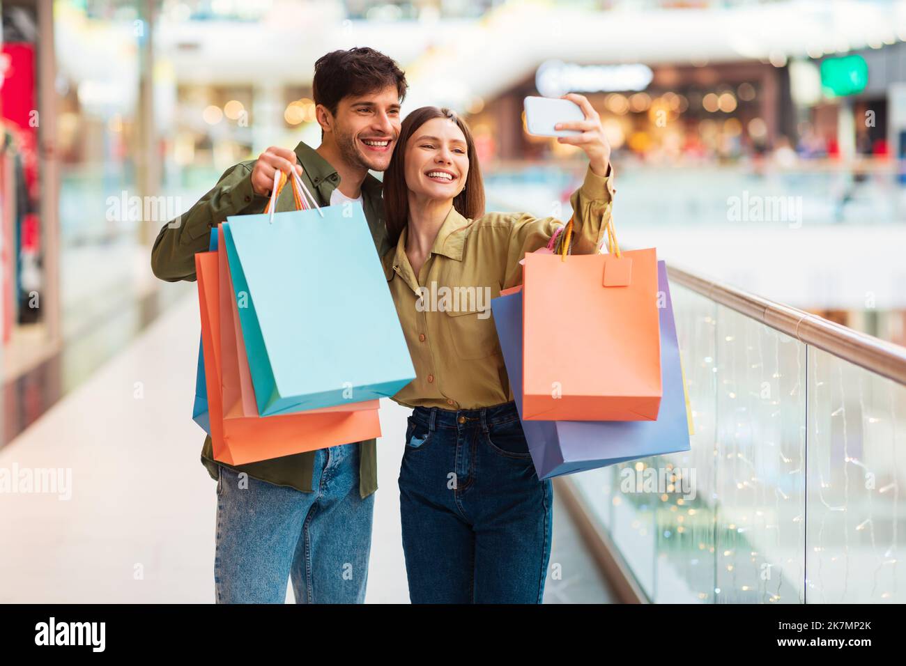 Happy Customers Couple Shopping And Making Selfie In Modern Mall Stock ...