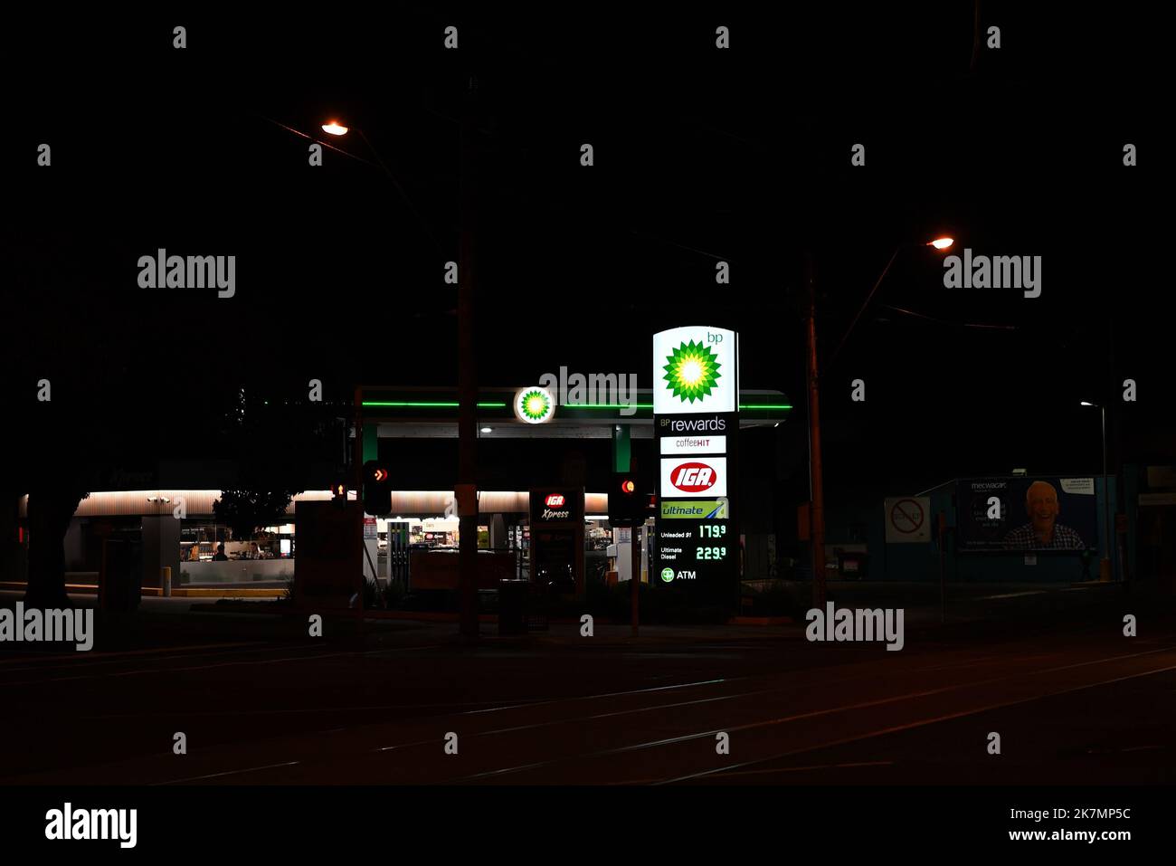 Suburban BP service station and IGA Xpress at night, with brightly ...
