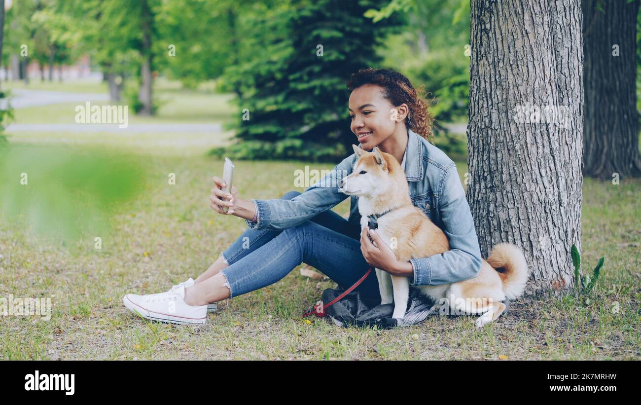 Attractive young African American girl is taking selfie with cute ...