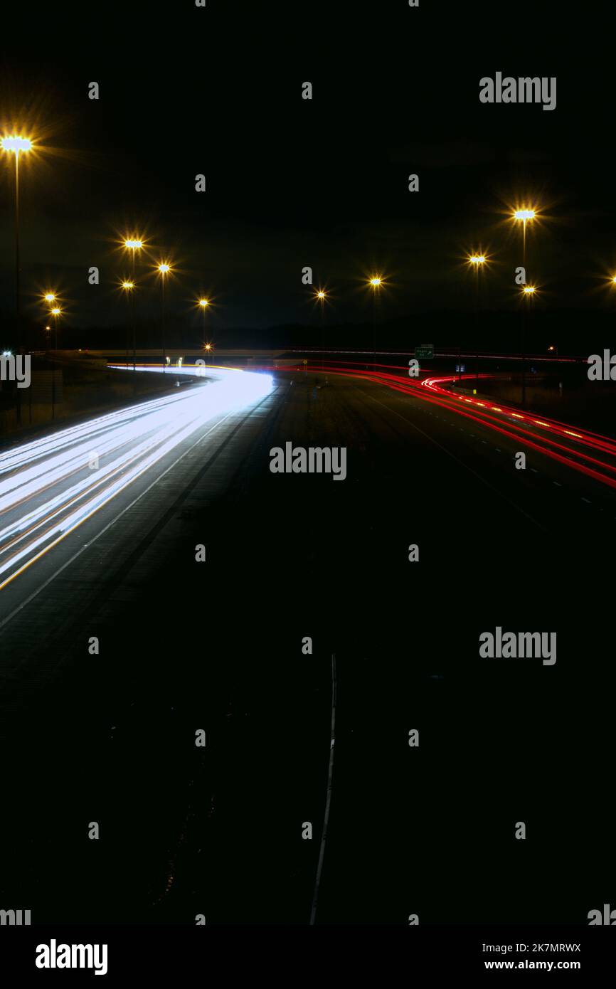 A vertical long exposure of traffic lights at night Stock Photo - Alamy
