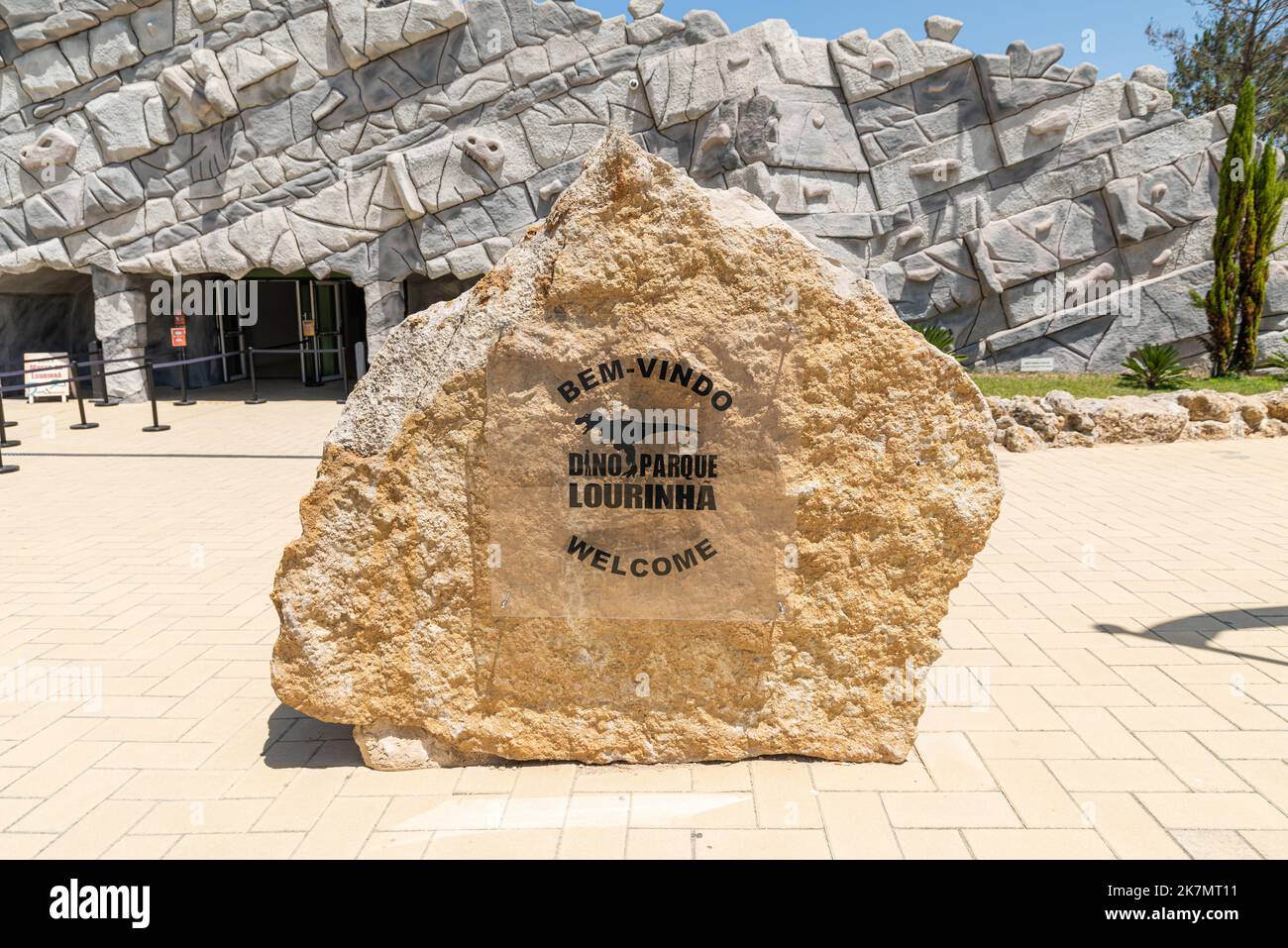 The main entrance with welcome poster to Dino Parque Lourinha with a ... The main entrance with welcome poster to Dino Parque Lourinha with a ...