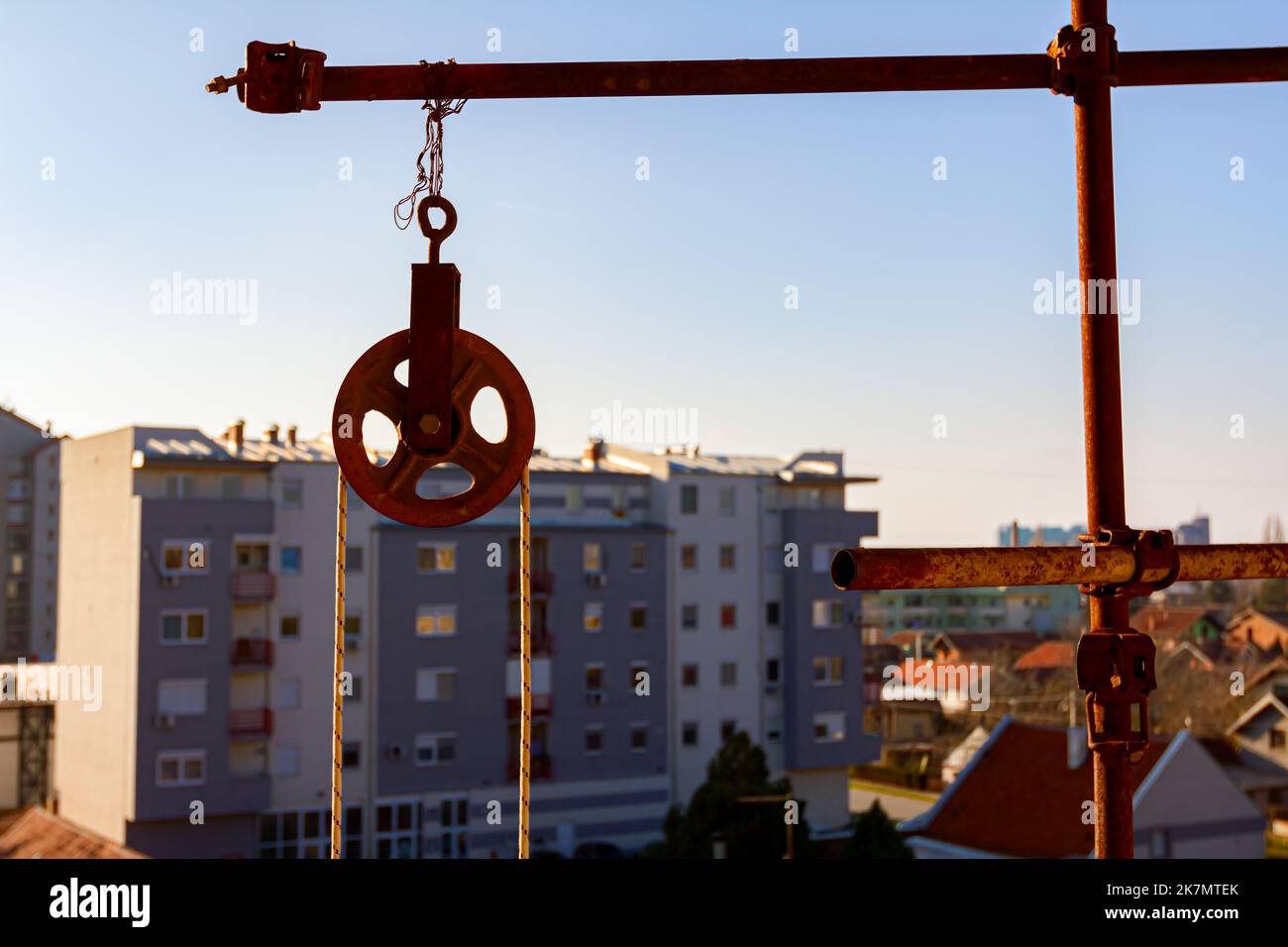 Rusted Iron industrial reel with rope attached for the scaffolding with ...