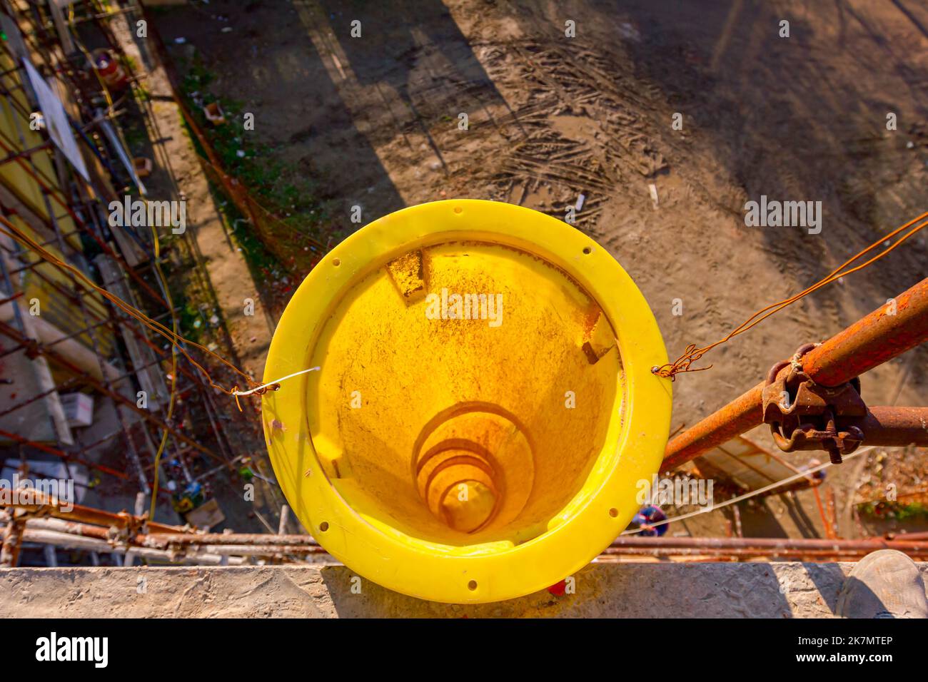Top view on hole of the yellow long tube placed next to building under ...