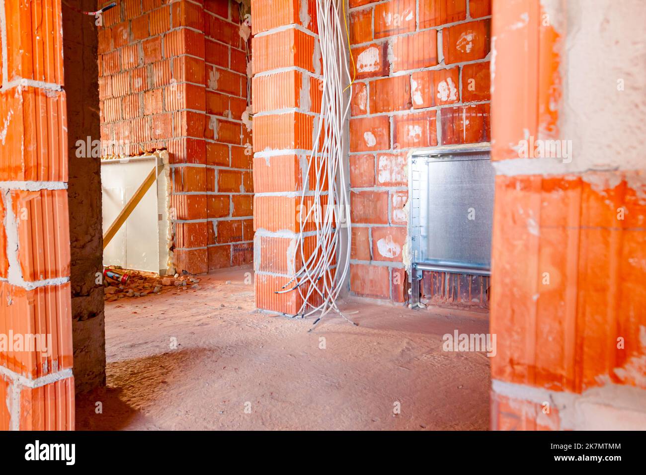 Bundle of various cables are hanging from ceiling, new empty ...