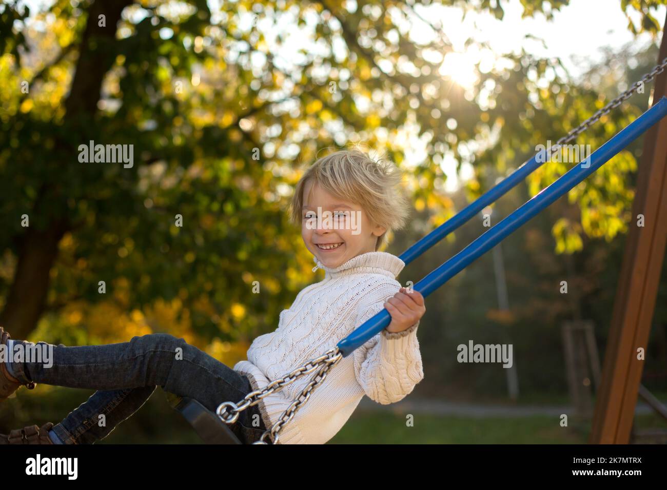 Happy children, playing with pet dog in autumn park on a sunny day ...