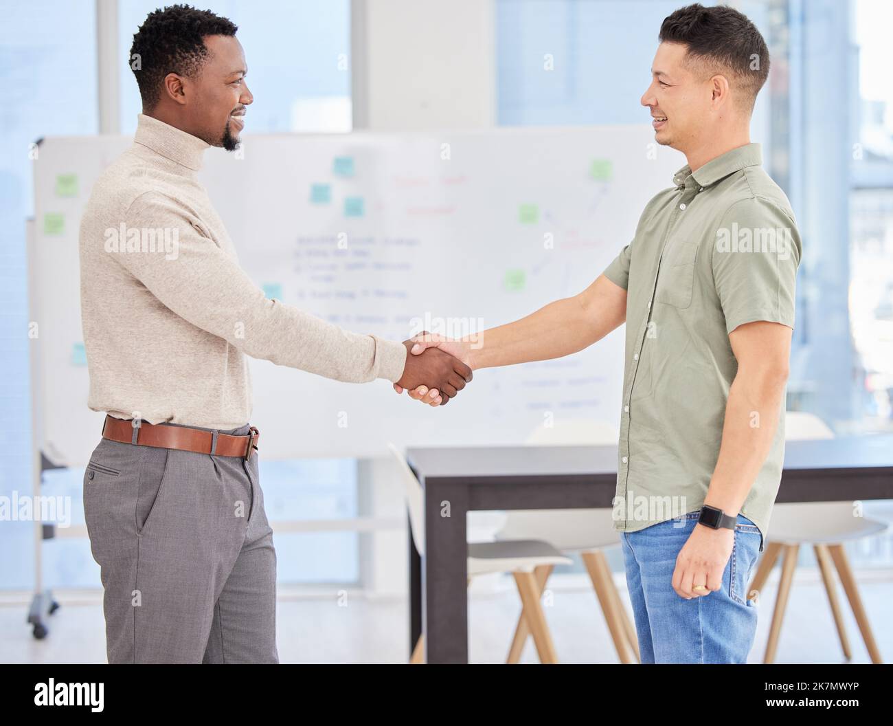Were heading towards greatness together. two businessmen shaking hands ...