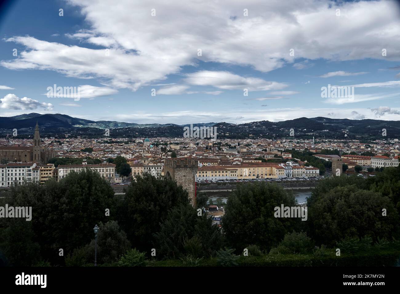 A distant shot of the city of Florence with buildings under clouded sky ...