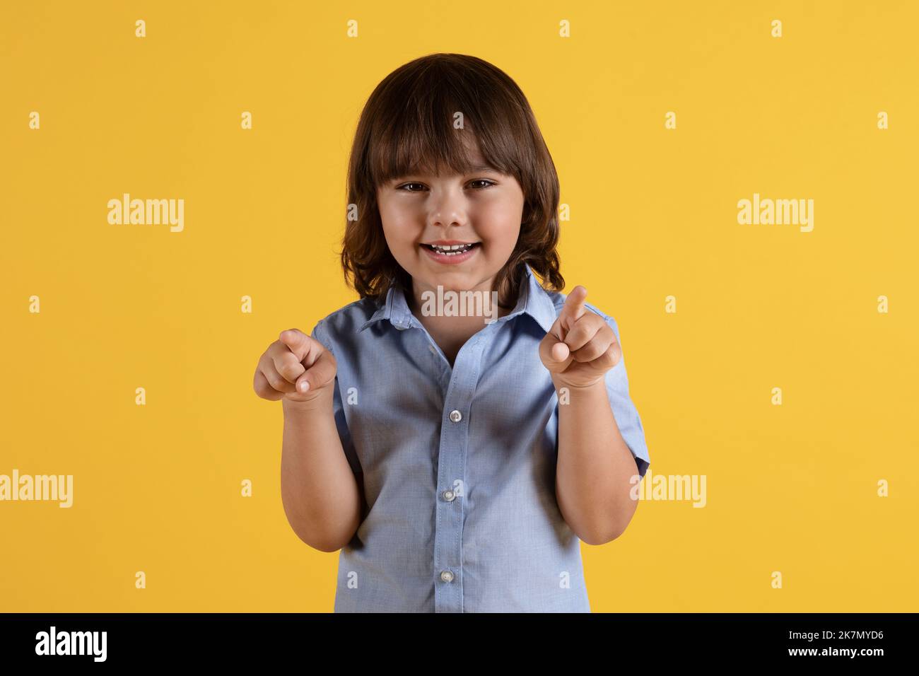 Studio portrait of happy playful little boy smiling to camera and ...