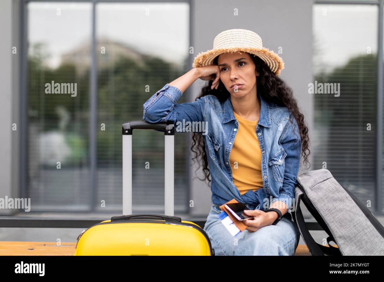 Upset young woman waiting for her delayed flight outdoors Stock Photo ...