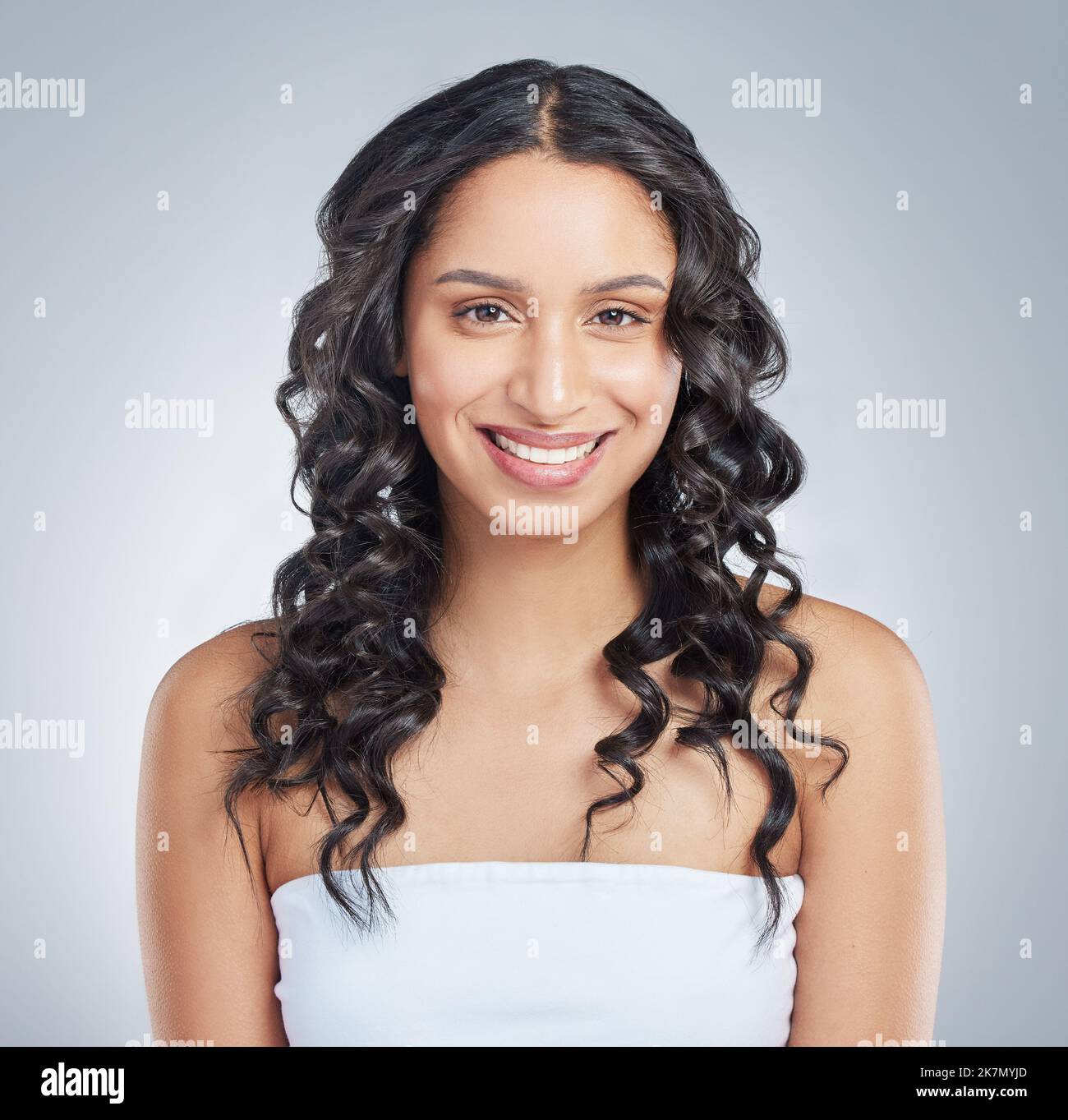 Feeling extra feminine today. an attractive young woman standing alone ...