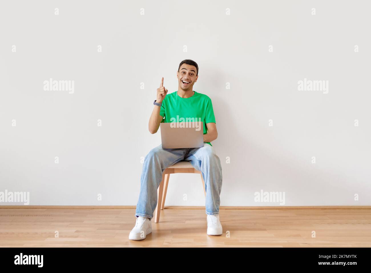 Inspiration concept. Excited arab man with laptop having great idea ...