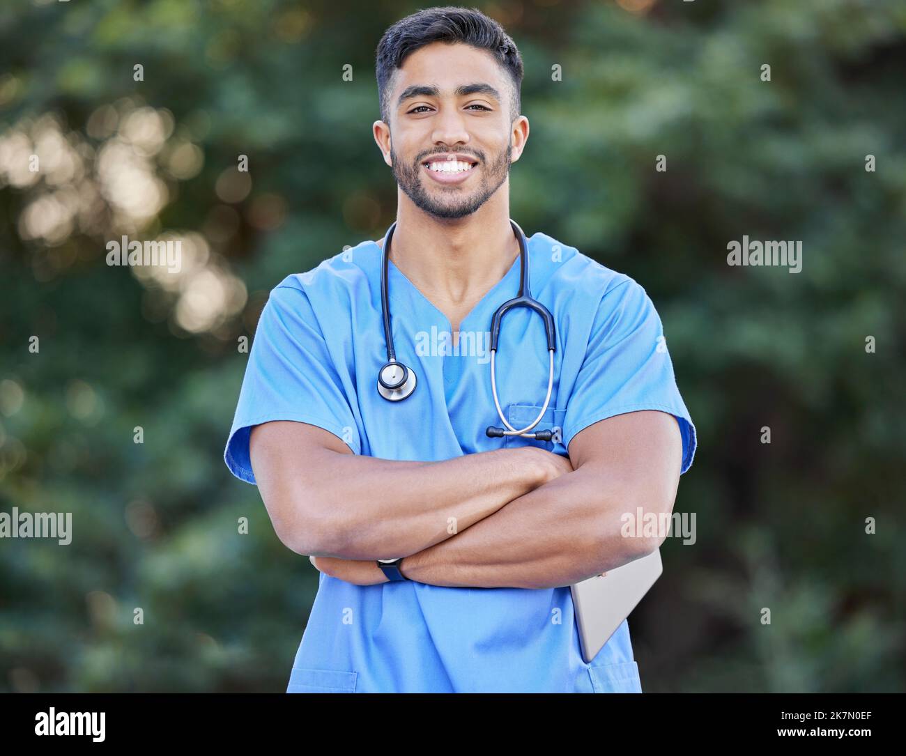 A healthcare worker who cares. a young male doctor standing with his ...