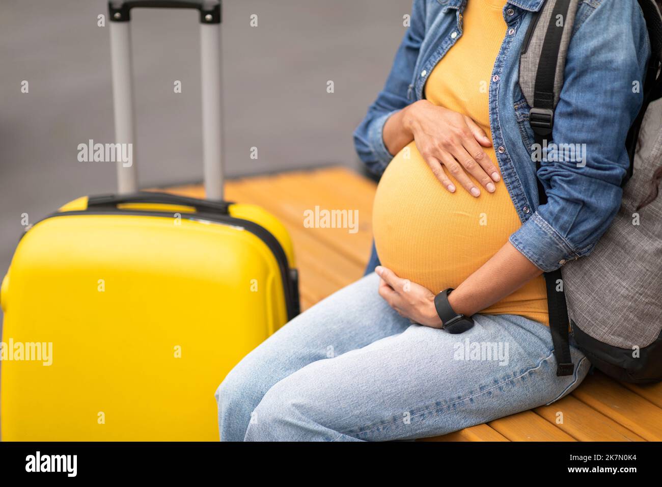 Unrecognizable expecting woman waiting for flight at airport Stock ...