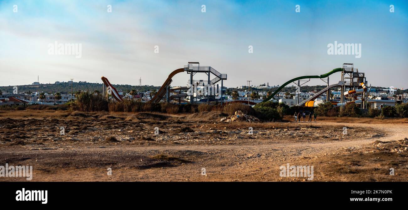 A group of people walking to water attractions with a background of a ...