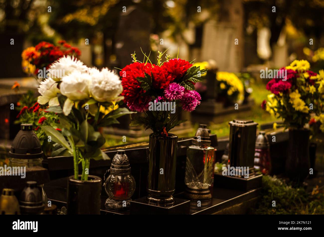 graves with flowers, decorations and candles backgrounds during all ...