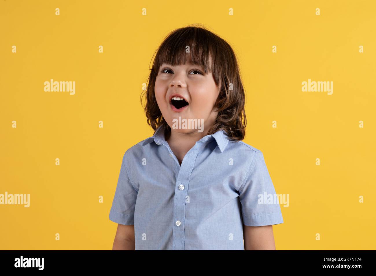 Wow, unbelievable. Surprised little boy enjoying amazing news, opening ...