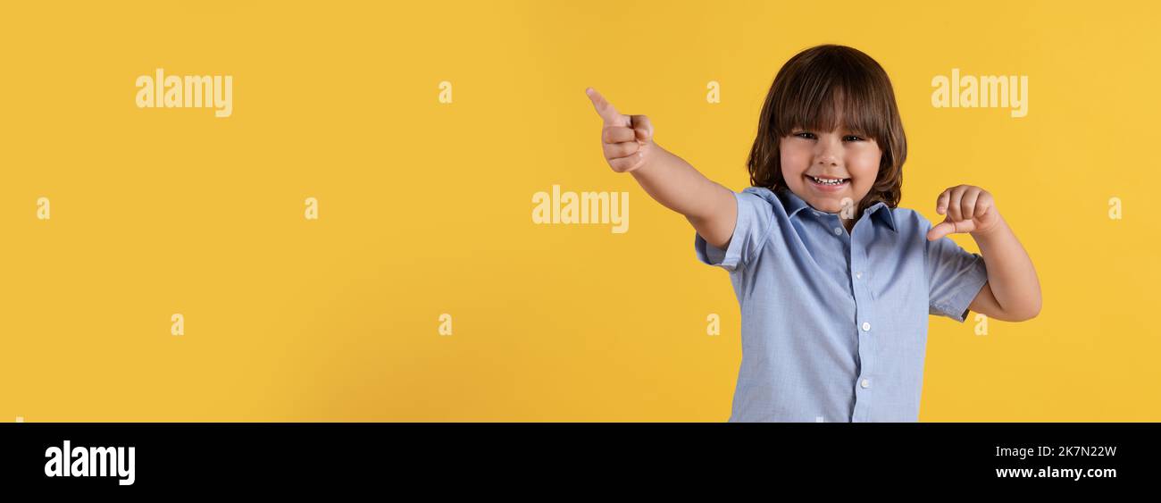 Great offer. Adorable little boy pointing aside and smiling, gesturing ...