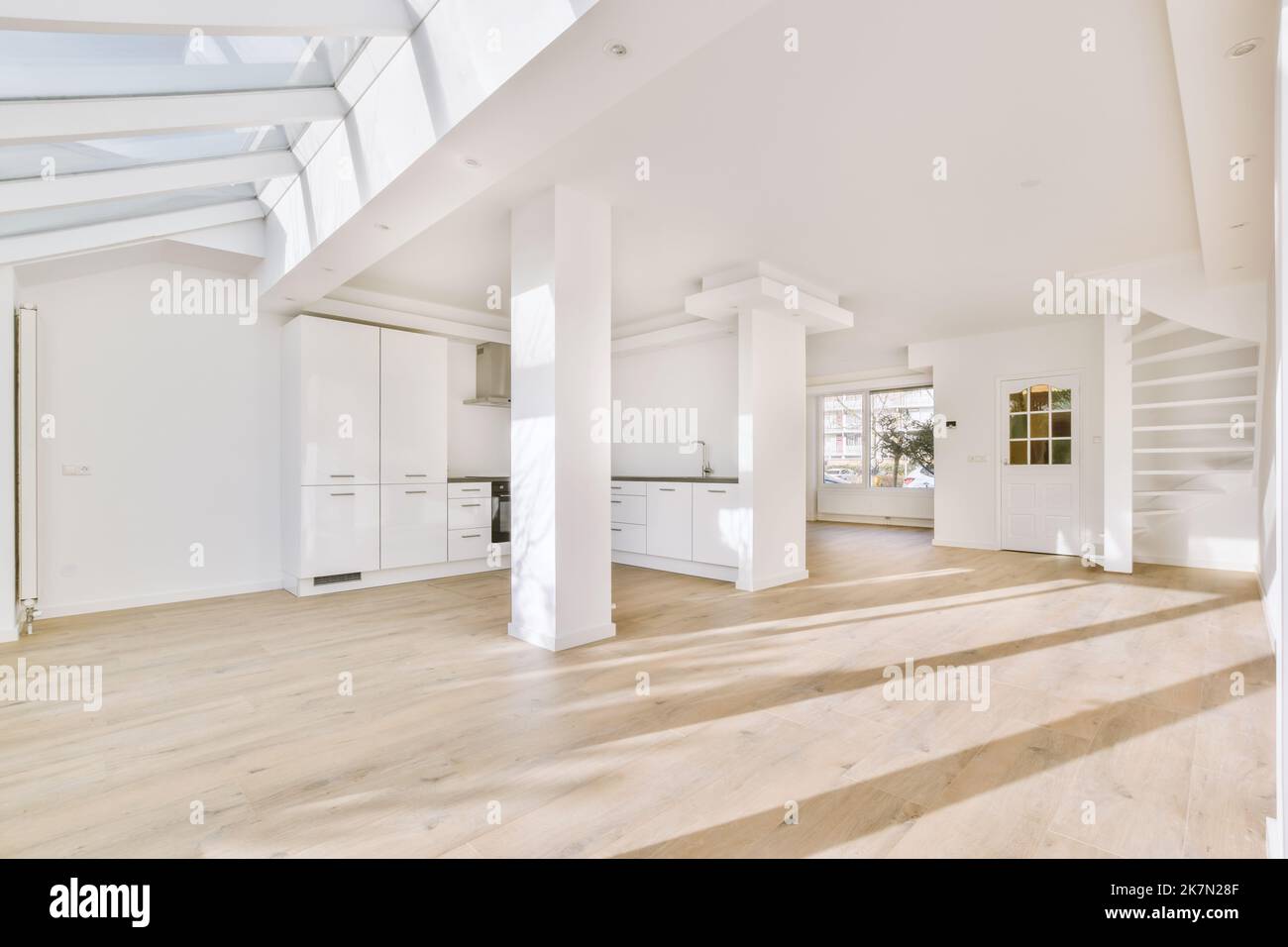 Interior of empty white kitchen with windows and wooden parquet floor ...