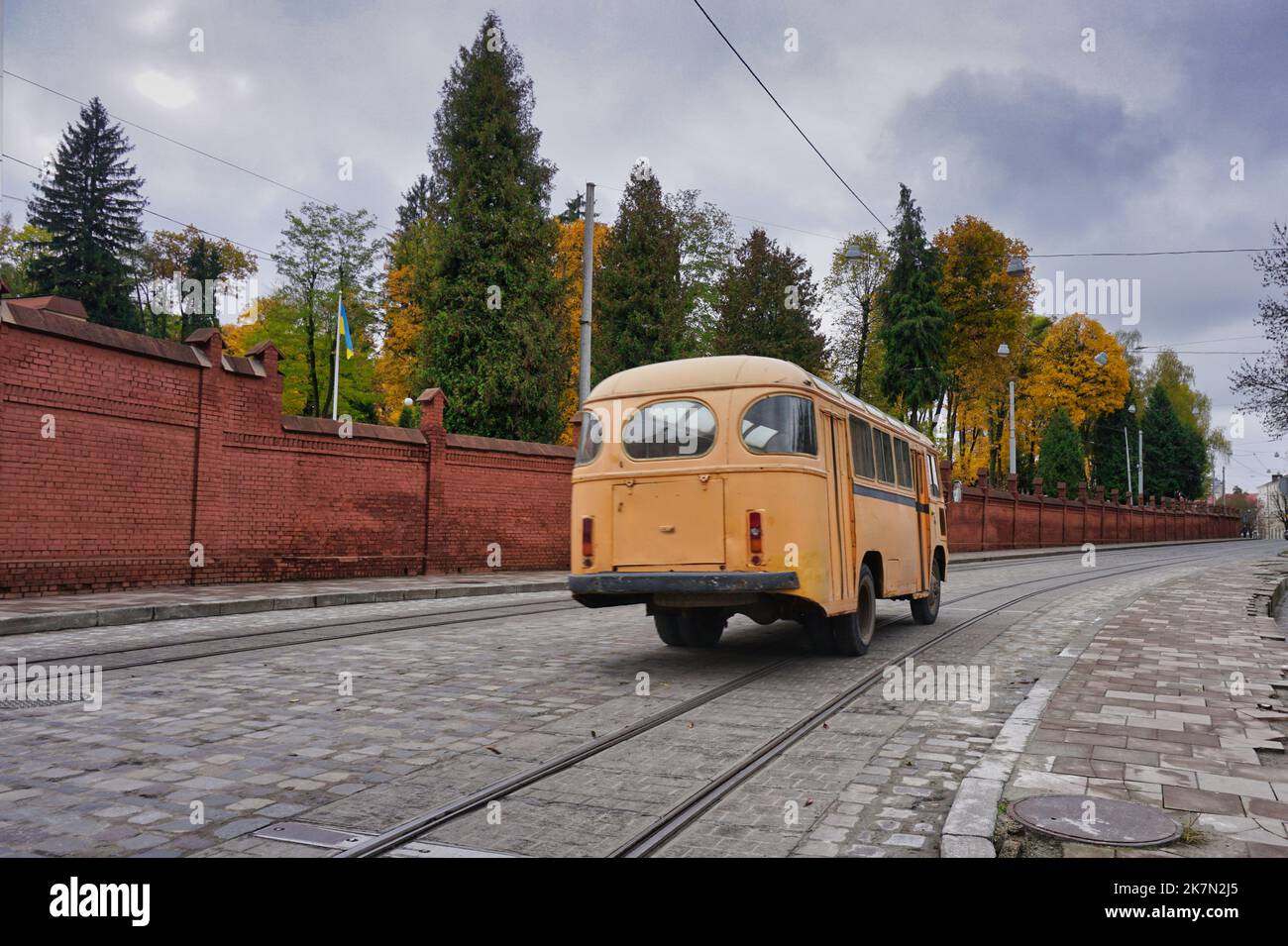 a yellow old bus passing through the city streets, ukraine lviv Stock ...