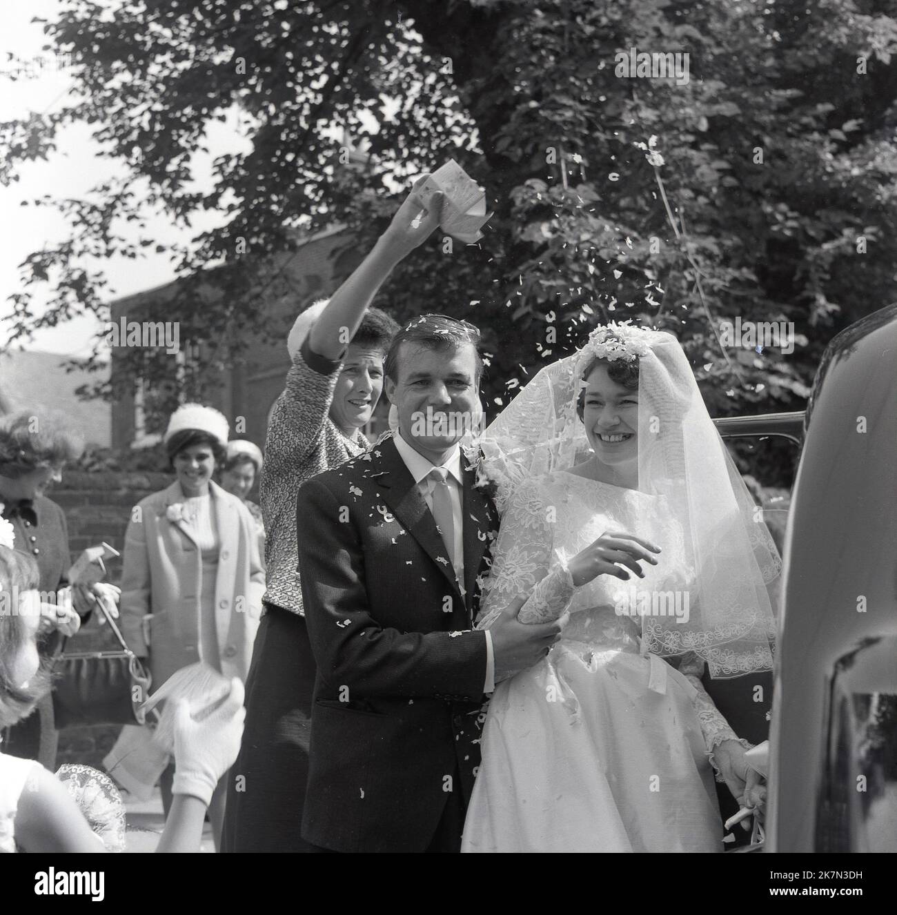 1960s, historical, a lady guest sprinkling the traditional confetti ...