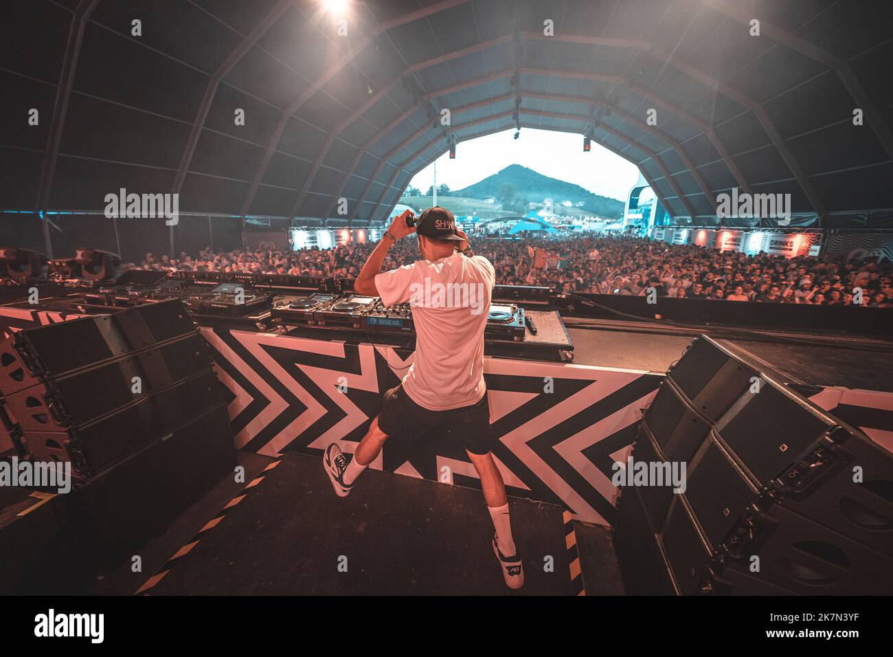 A behind stage high-angle of rear male singer performing on the stage ...