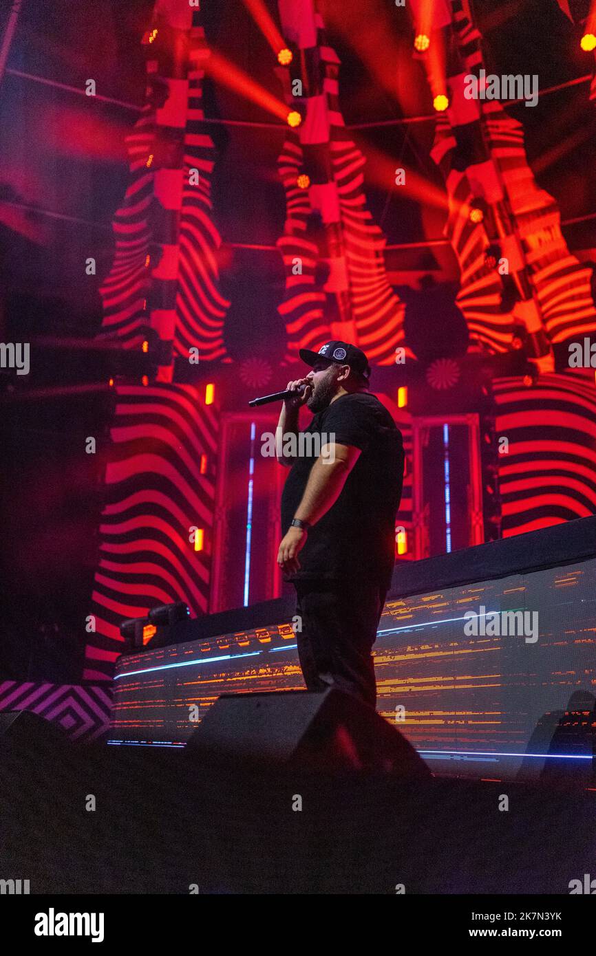 A vertical low-angle of a male singer performing on the stage during ...