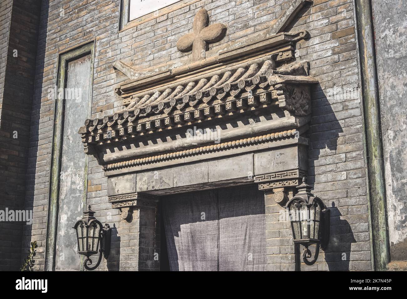 The stone cross over the gate of Mofan Bookstore the former site of the ...