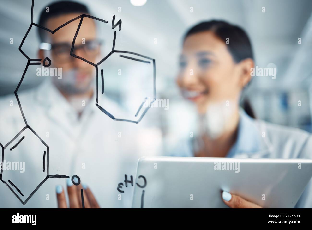 Step by step well solve it. Shot two a young scientists solving equations on a glass screen in a ...