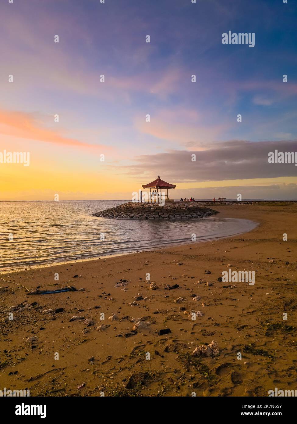 A mesmerizing view of the golden sunset over the sea in Sanur Beach ...