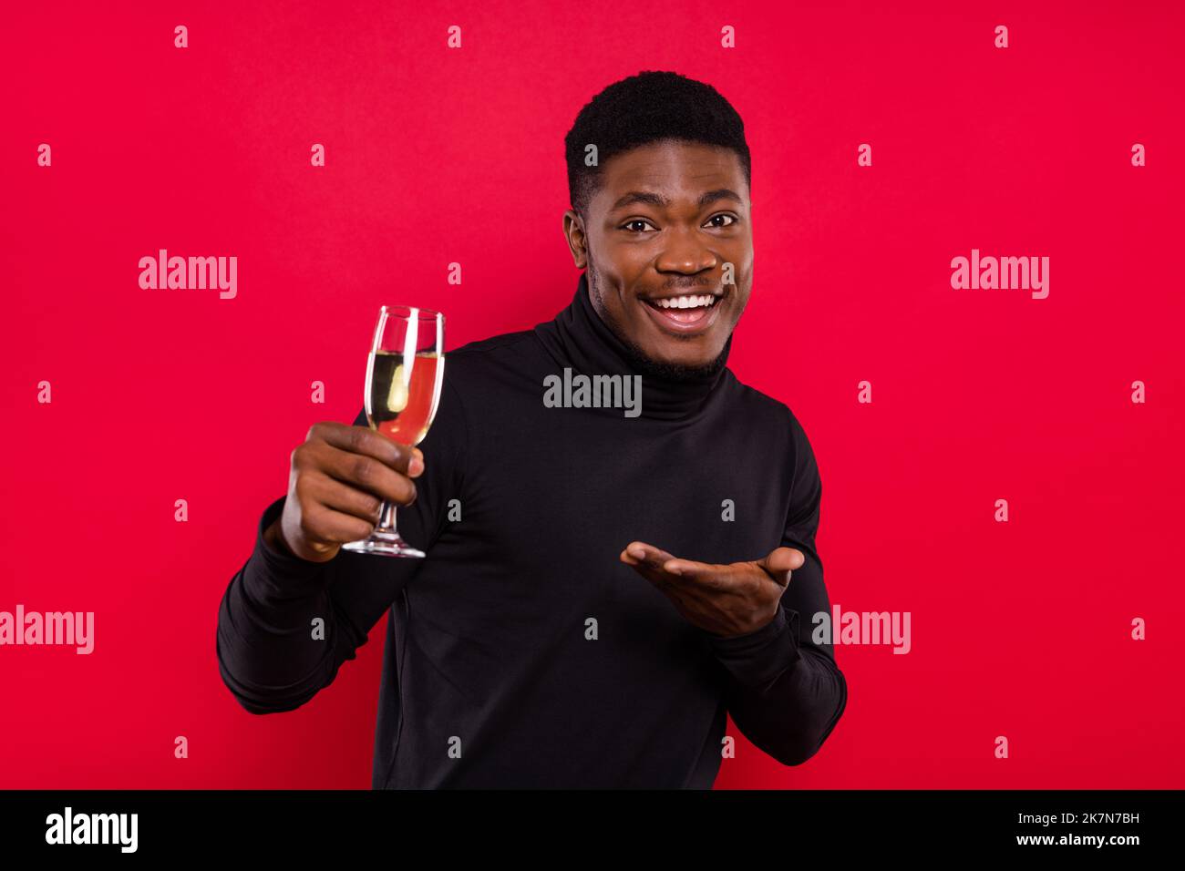 Portrait of attractive cheerful guy drinking champagne having fun eve ...