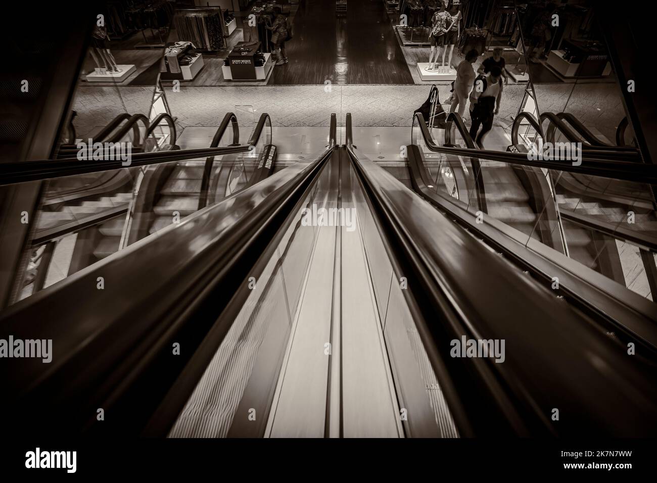 A grayscale top view of escalator railing in a department store Stock ...