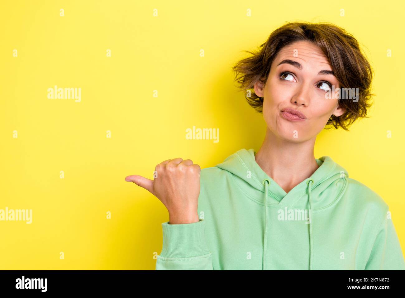 Photo portrait of lovely young woman look skeptical point empty space ...