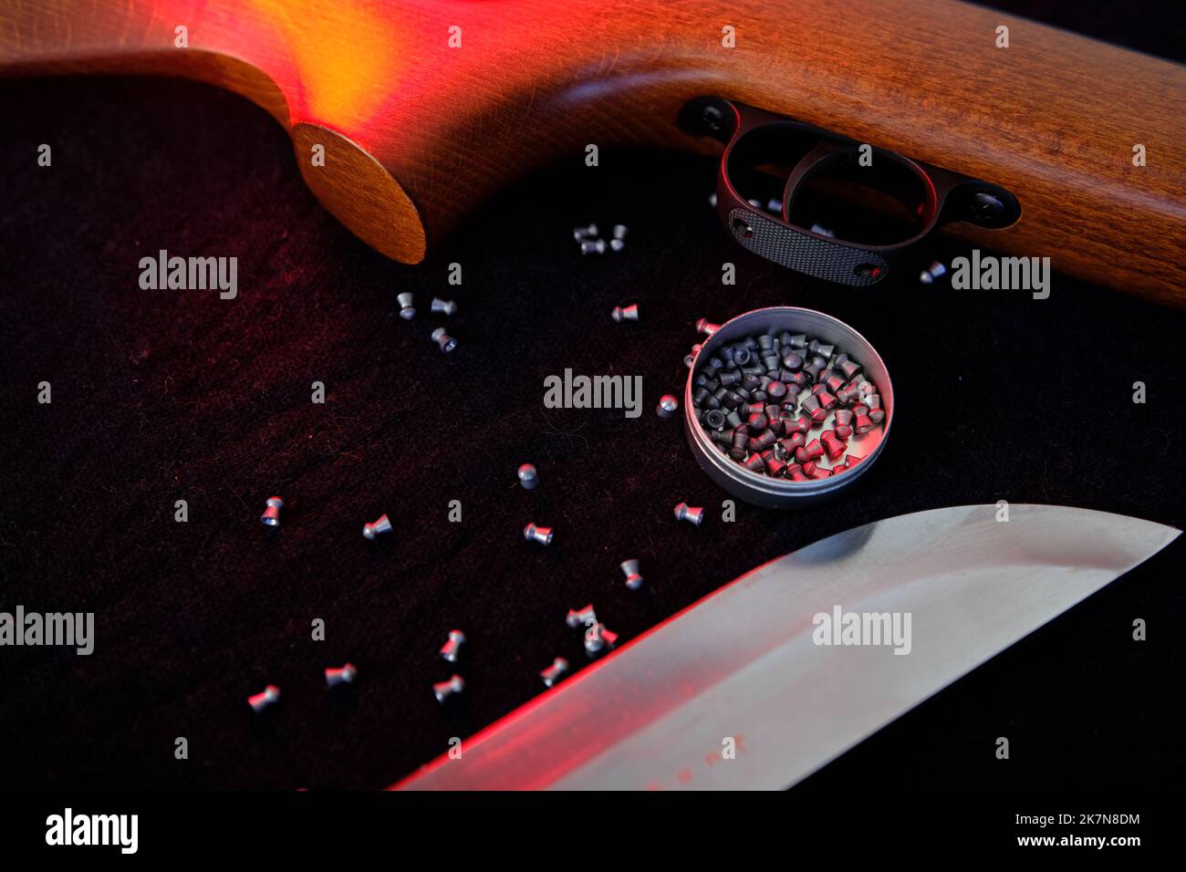 Rifle gun trigger with air pellets and knife for hunting on cloth dark ...