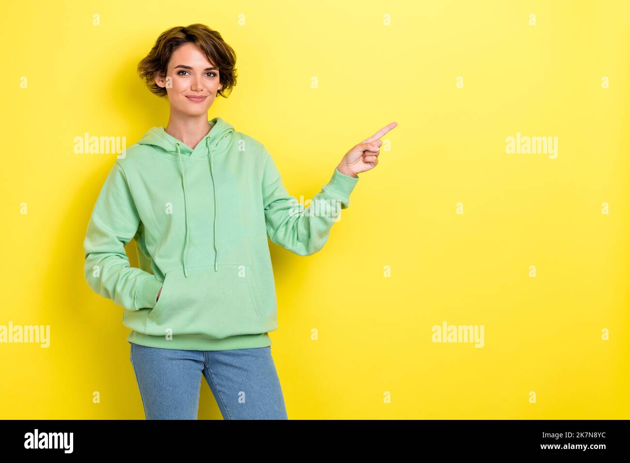 Photo portrait of gorgeous young lady point empty space hand hold ...
