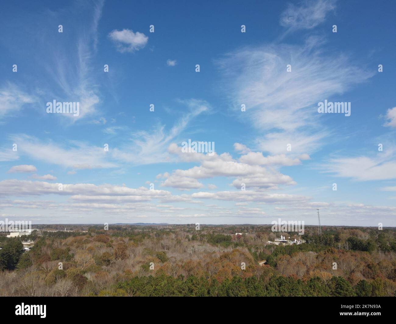 Some thick and thin clouds scattered in a deep blue sky similar to ...