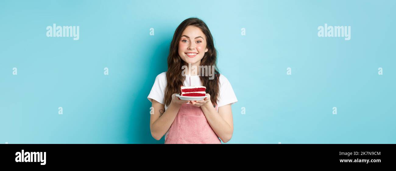 Celebration and holiday. Smiling young woman celebrating birthday ...