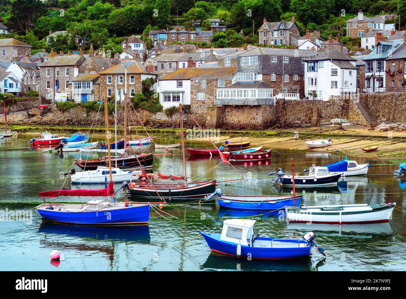 Traditional stone houses and colorful fishing boats in picturesque ...