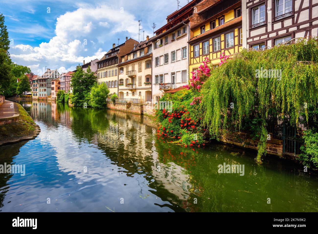 Traditional colorful houses reflecting in the Ill river in La Petite ...